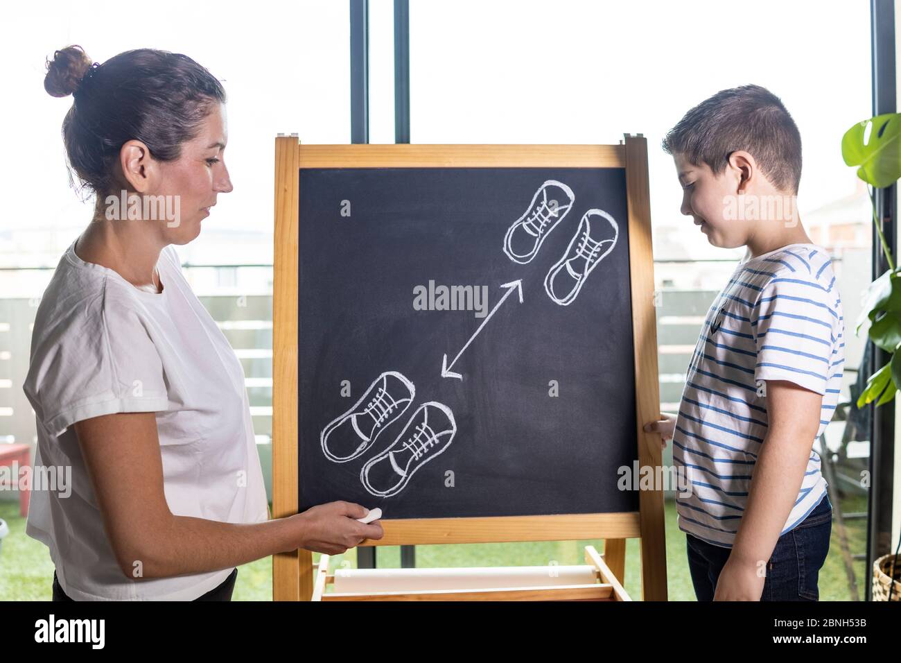 Mother teaching her son what social distance is Stock Photo - Alamy