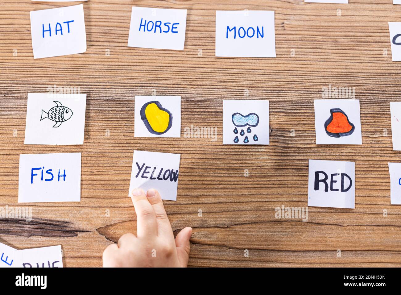 Little kid playing with cards of words and pictures. Time to learn ...