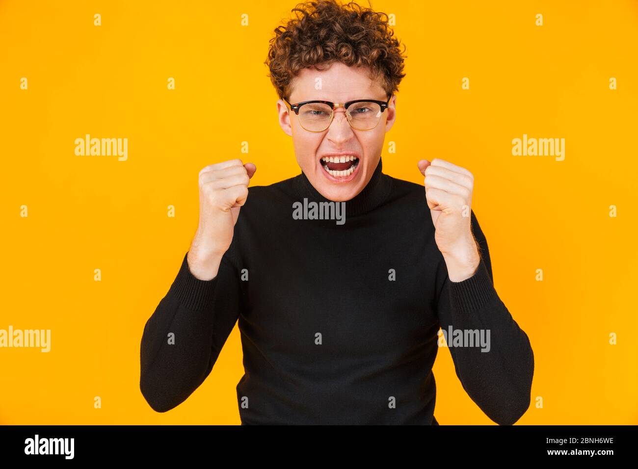 Image of young angry man in eyeglasses screaming at camera with ...