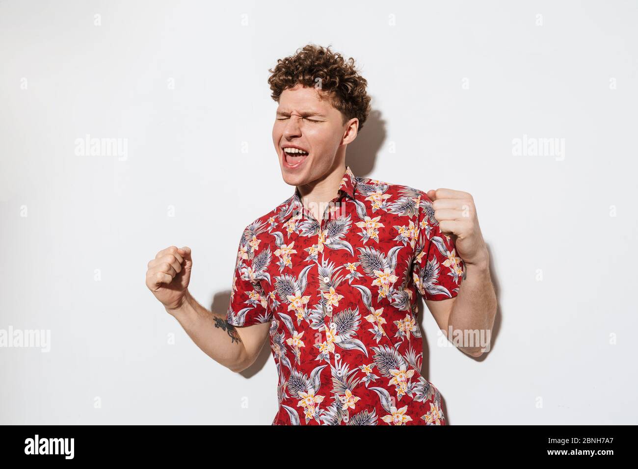 Image of caucasian delighted man screaming and making winner gesture ...