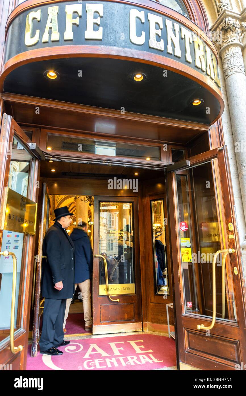 A doorman is guiding potential guests at the entrance of Cafe Central ...