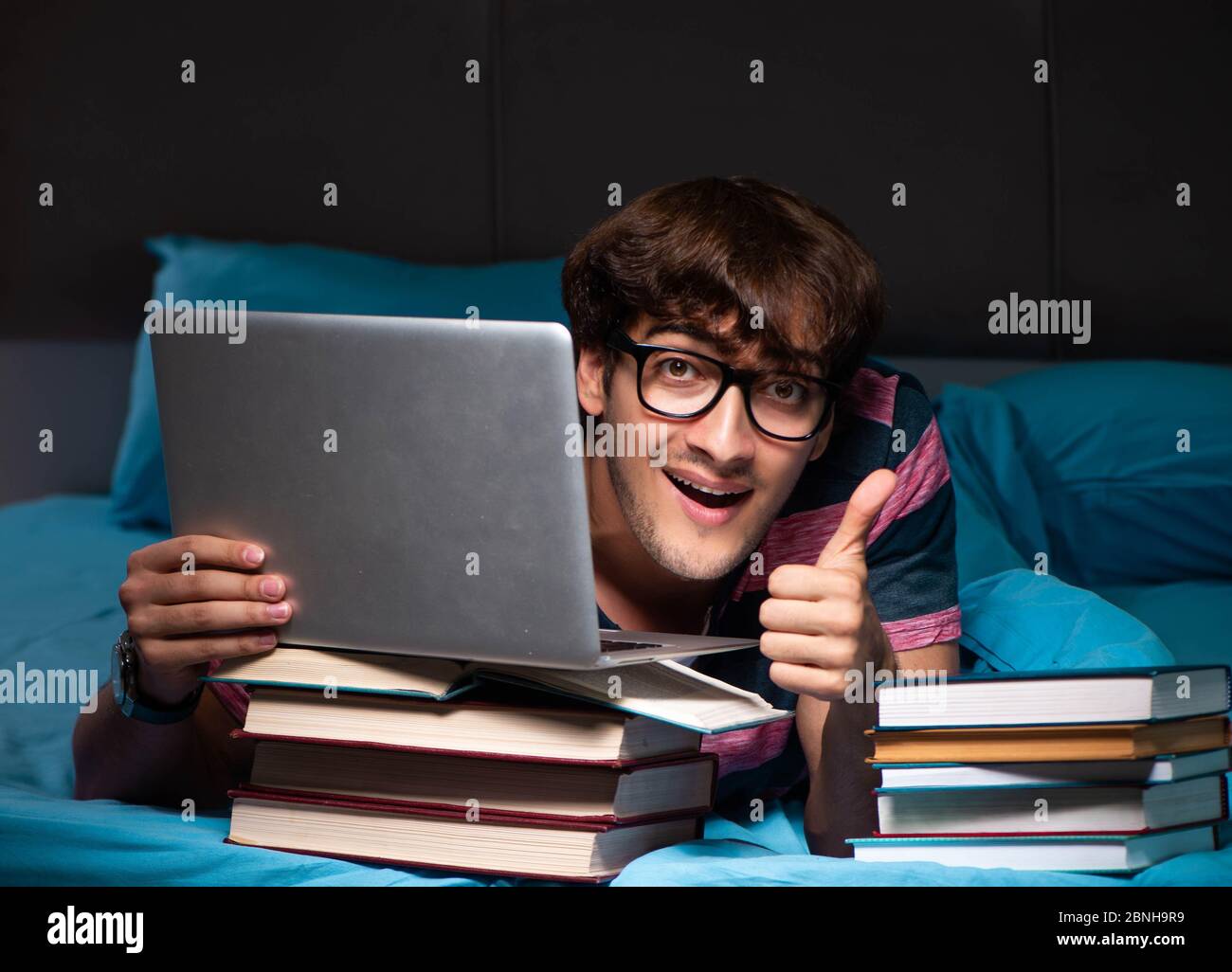 The young student preparing for exams at night at home Stock Photo - Alamy