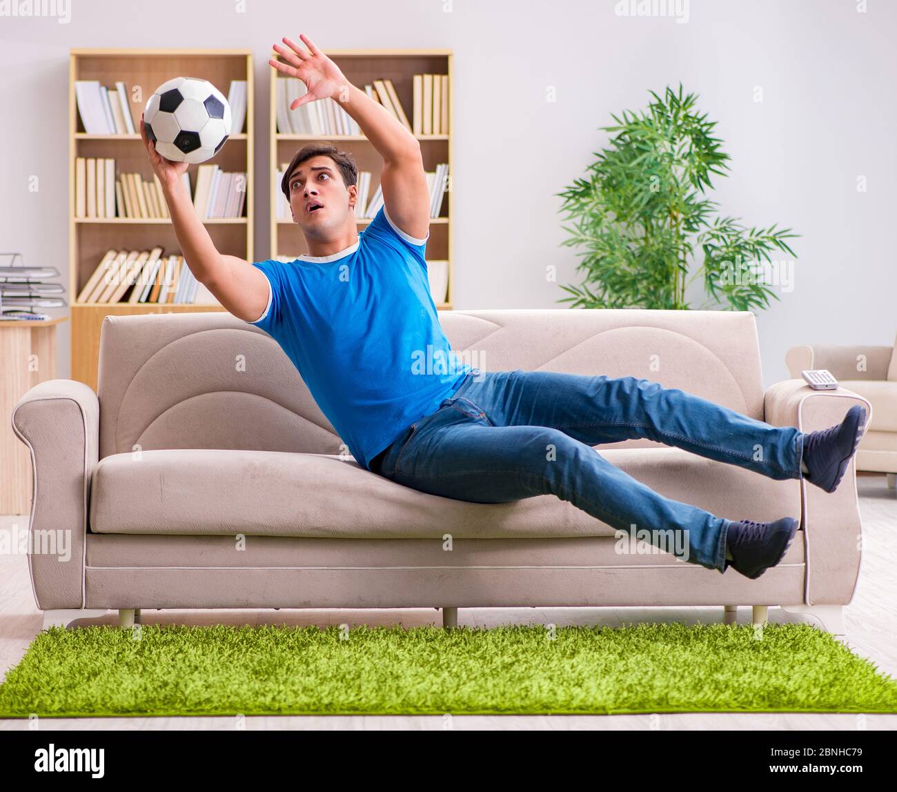 The man watching football at home sitting in couch Stock Photo - Alamy