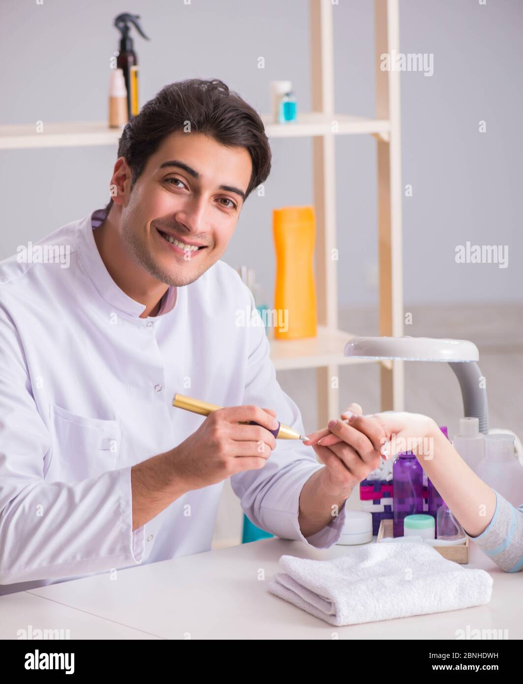 The hands during manicure care session Stock Photo - Alamy