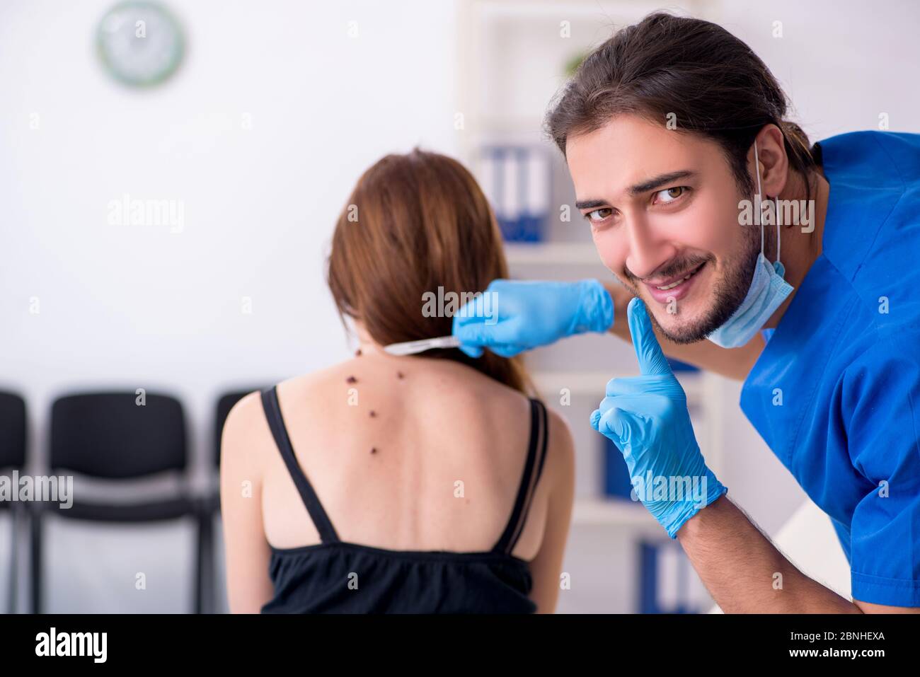 Young woman visiting doctor dermatologist Stock Photo - Alamy