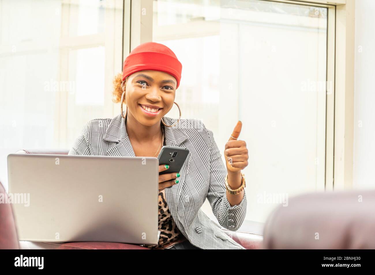 beautiful young african muslim business woman using her laptop computer ...
