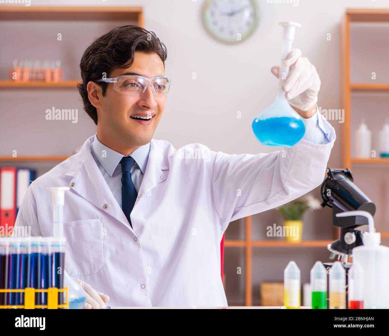 The young handsome biochemist working in the lab Stock Photo - Alamy