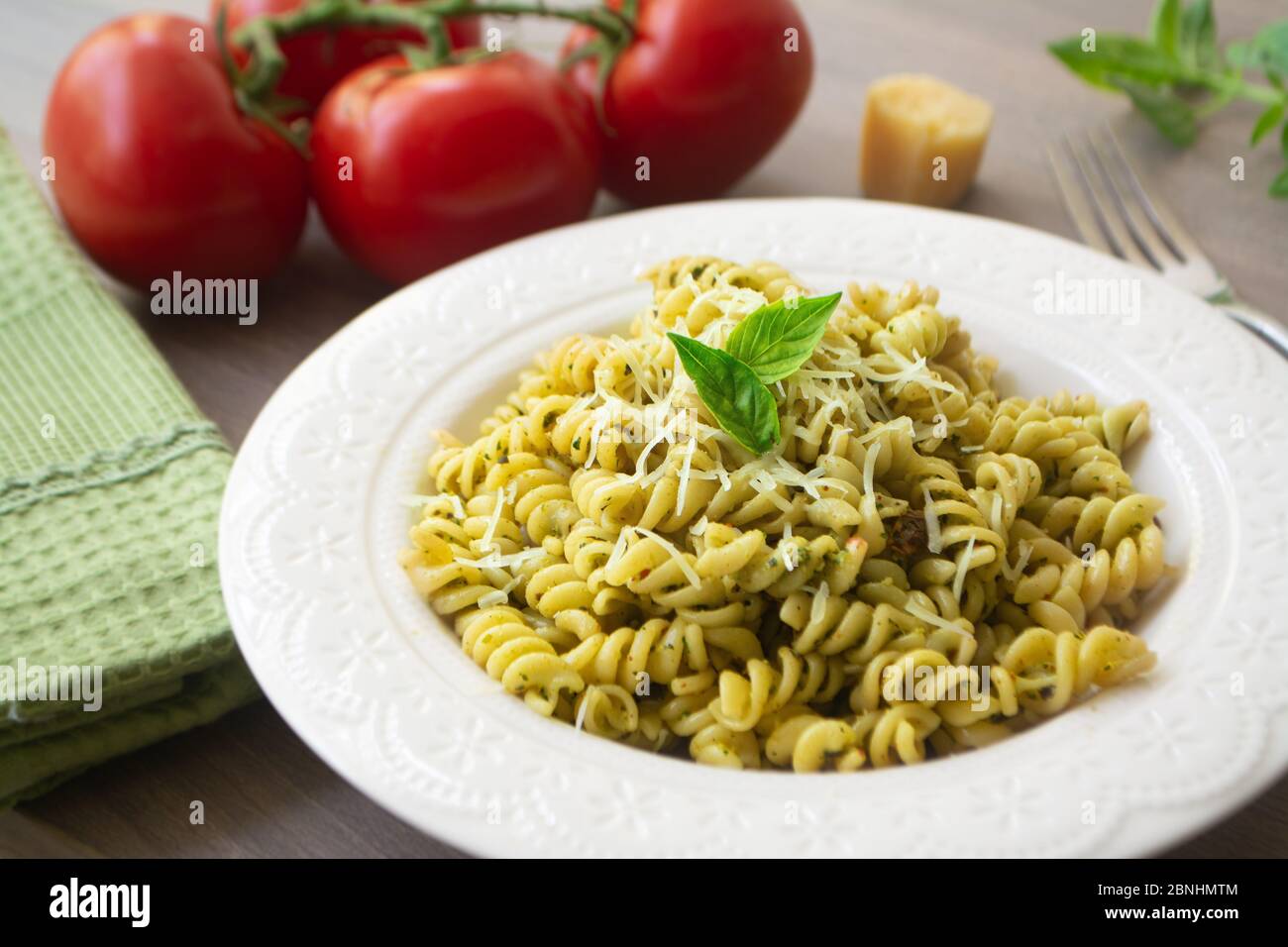 Traditional Italian vegetarian pasta fusilli with fresh homemade basil ...