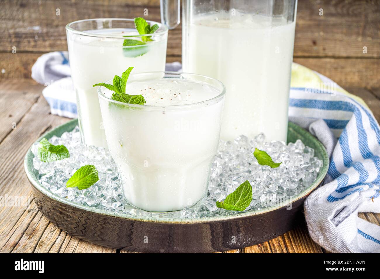 Cold Indian drink Lassi, iced coconut Lassi drink with mint leaf ...