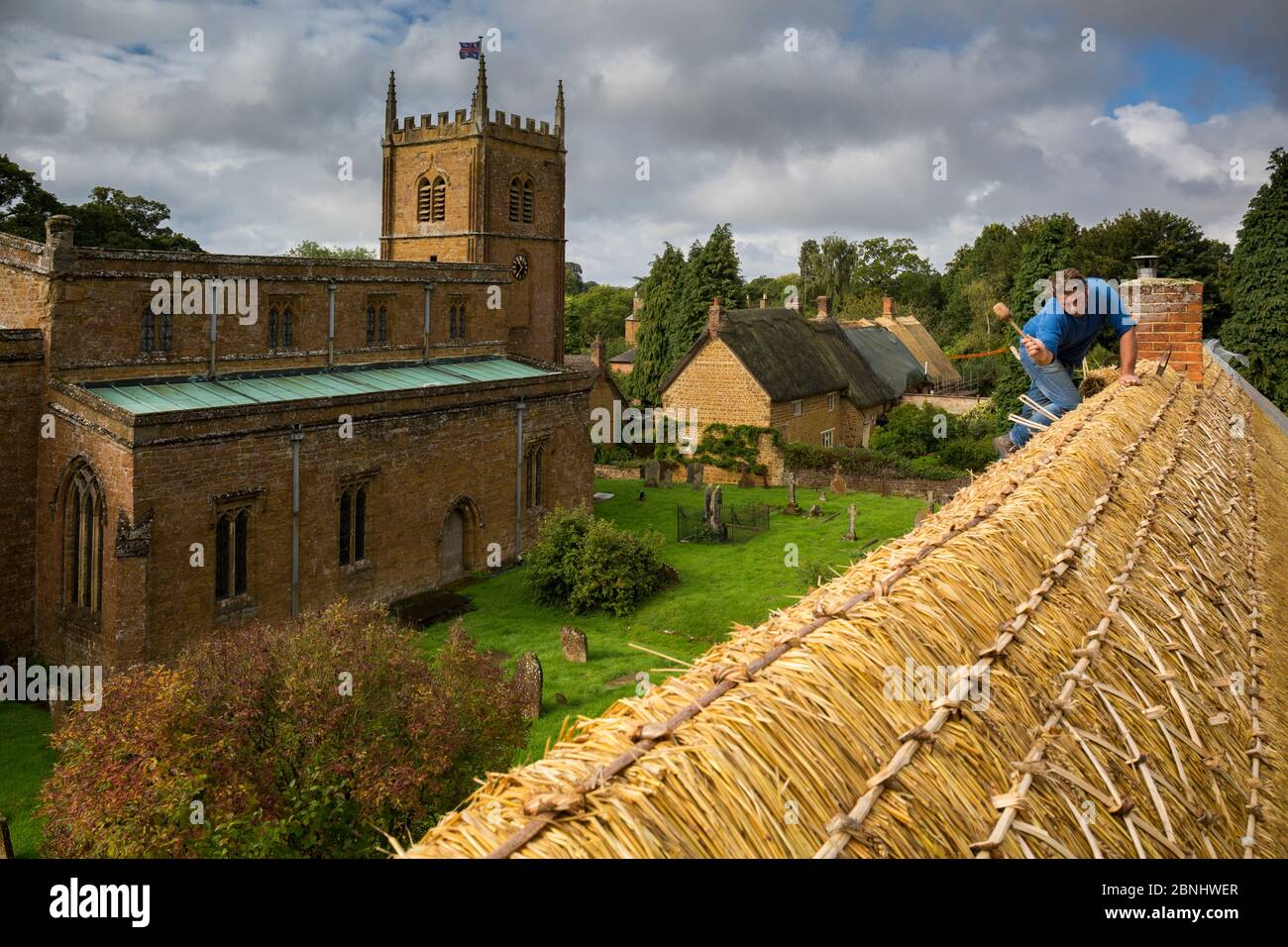 Dan Quatermain, master thatcher working on a thatched roof in Wroxton ...