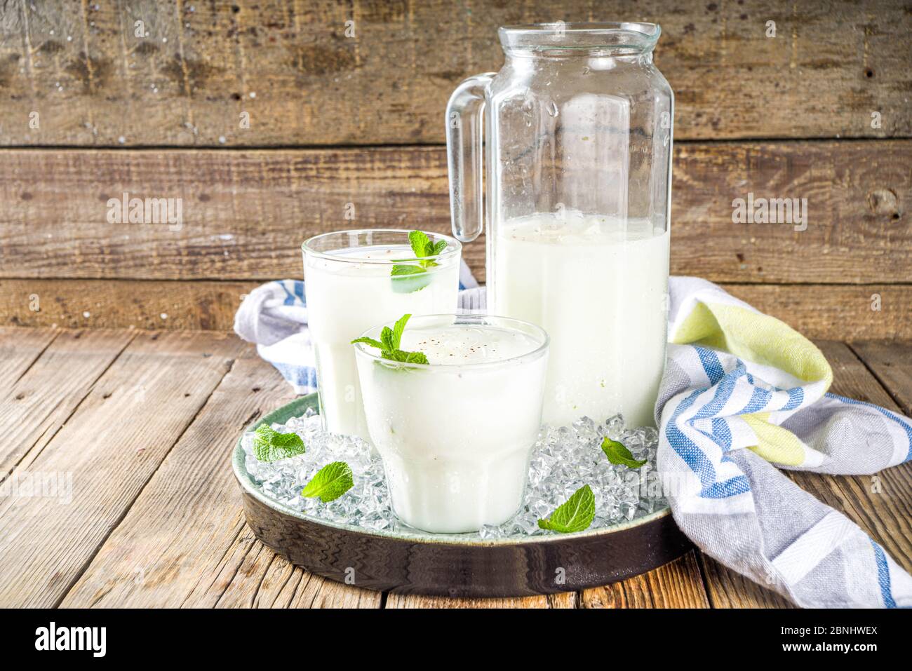 Cold Indian drink Lassi, iced coconut Lassi drink with mint leaf ...