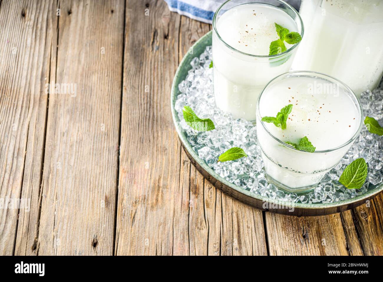 Cold Indian drink Lassi, iced coconut Lassi drink with mint leaf ...