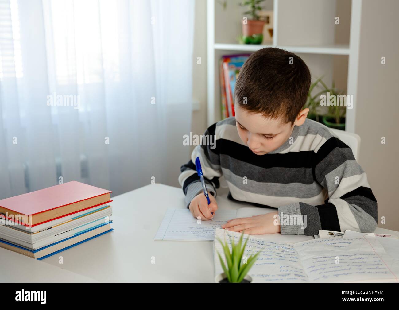 Child doing school work hi-res stock photography and images - Alamy