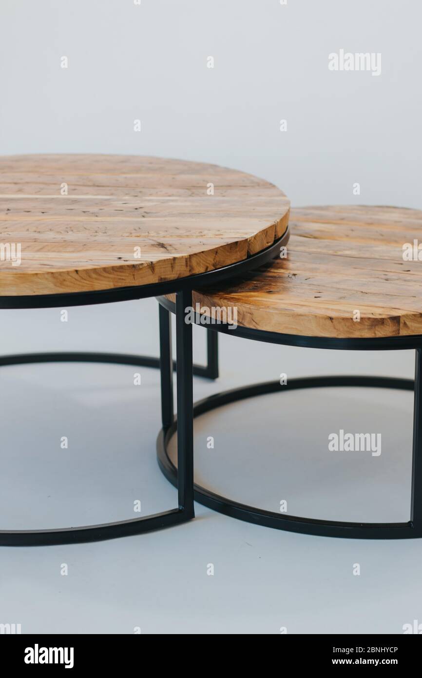 Closeup shot of two circular wooden tables made of black metal Stock ...