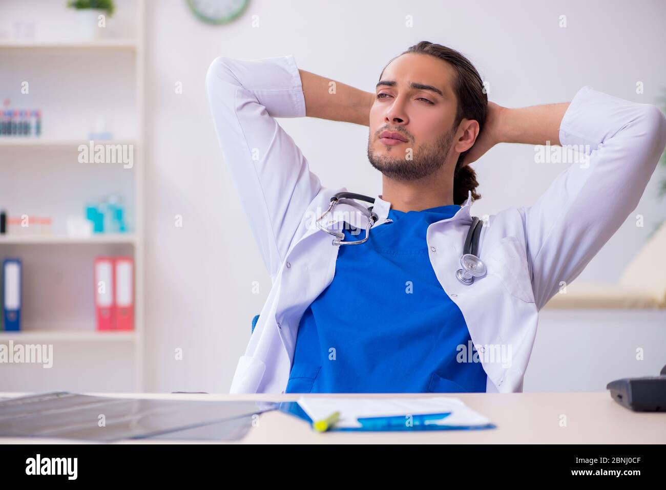 Young doctor being tired after night shift Stock Photo - Alamy