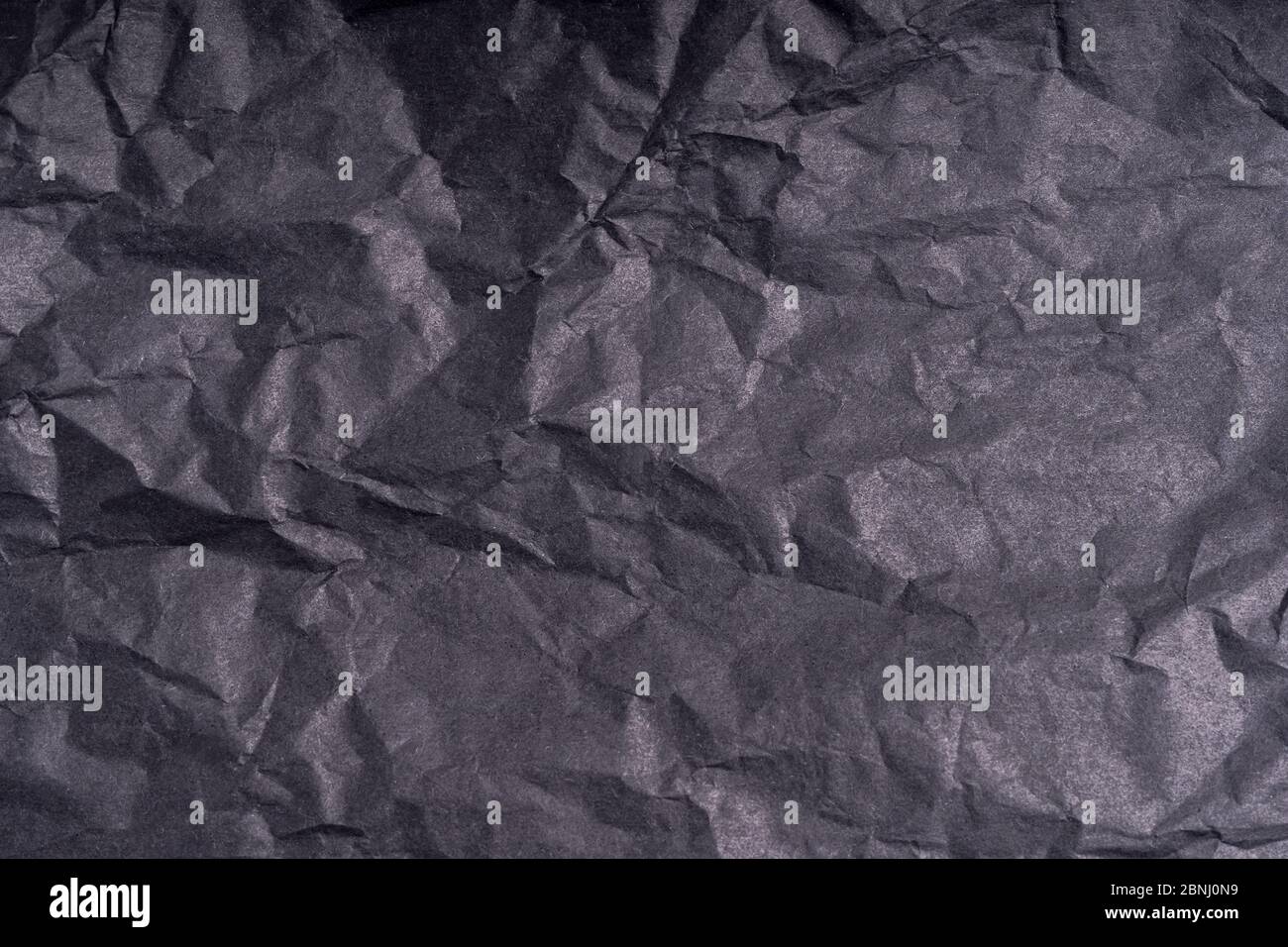 Dark wrinkled creased black paper poster texture. Blank crumpled grainy ...