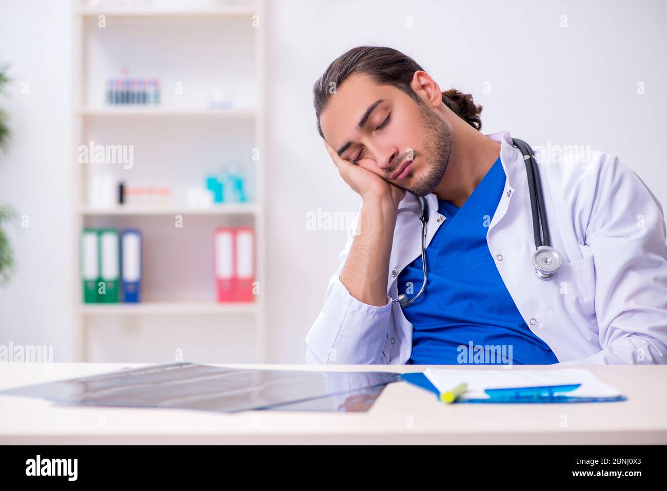 Young doctor being tired after night shift Stock Photo - Alamy
