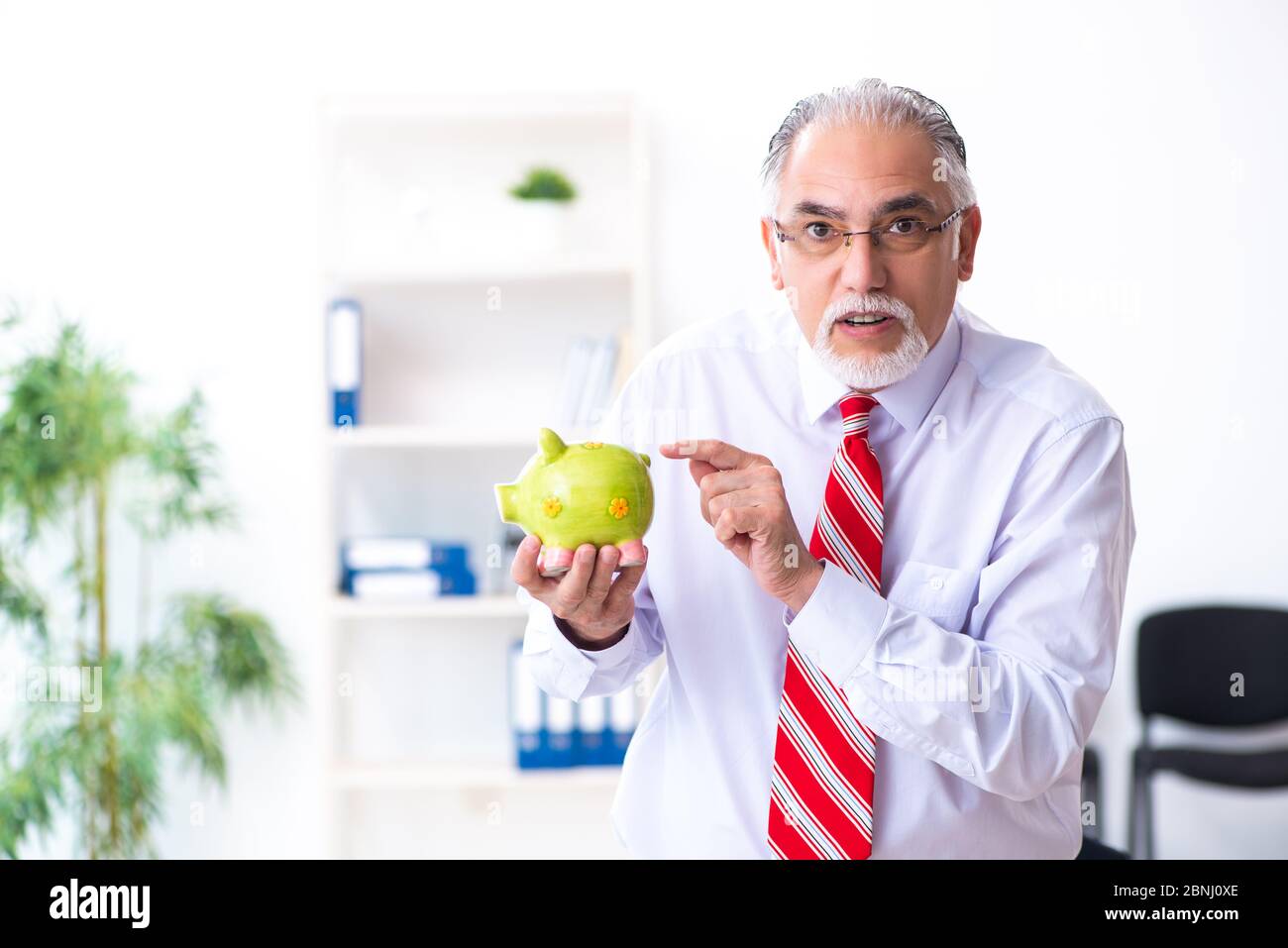 Old accountant in budget planning concept Stock Photo - Alamy