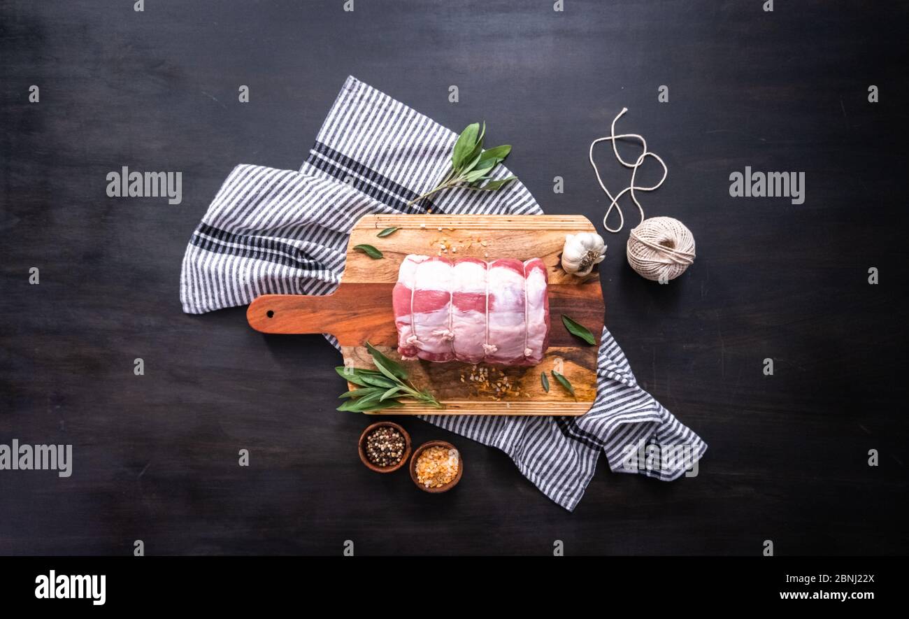 Flat lay. Uncooked boneless pork roast on the cutting board Stock Photo ...