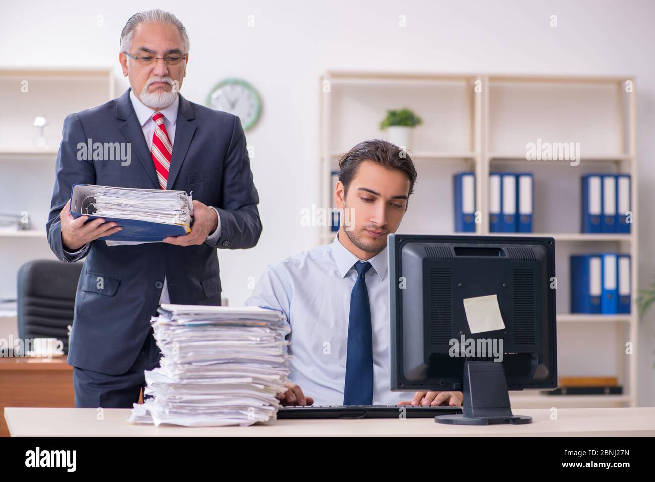 Old boss and young employee in the office Stock Photo - Alamy