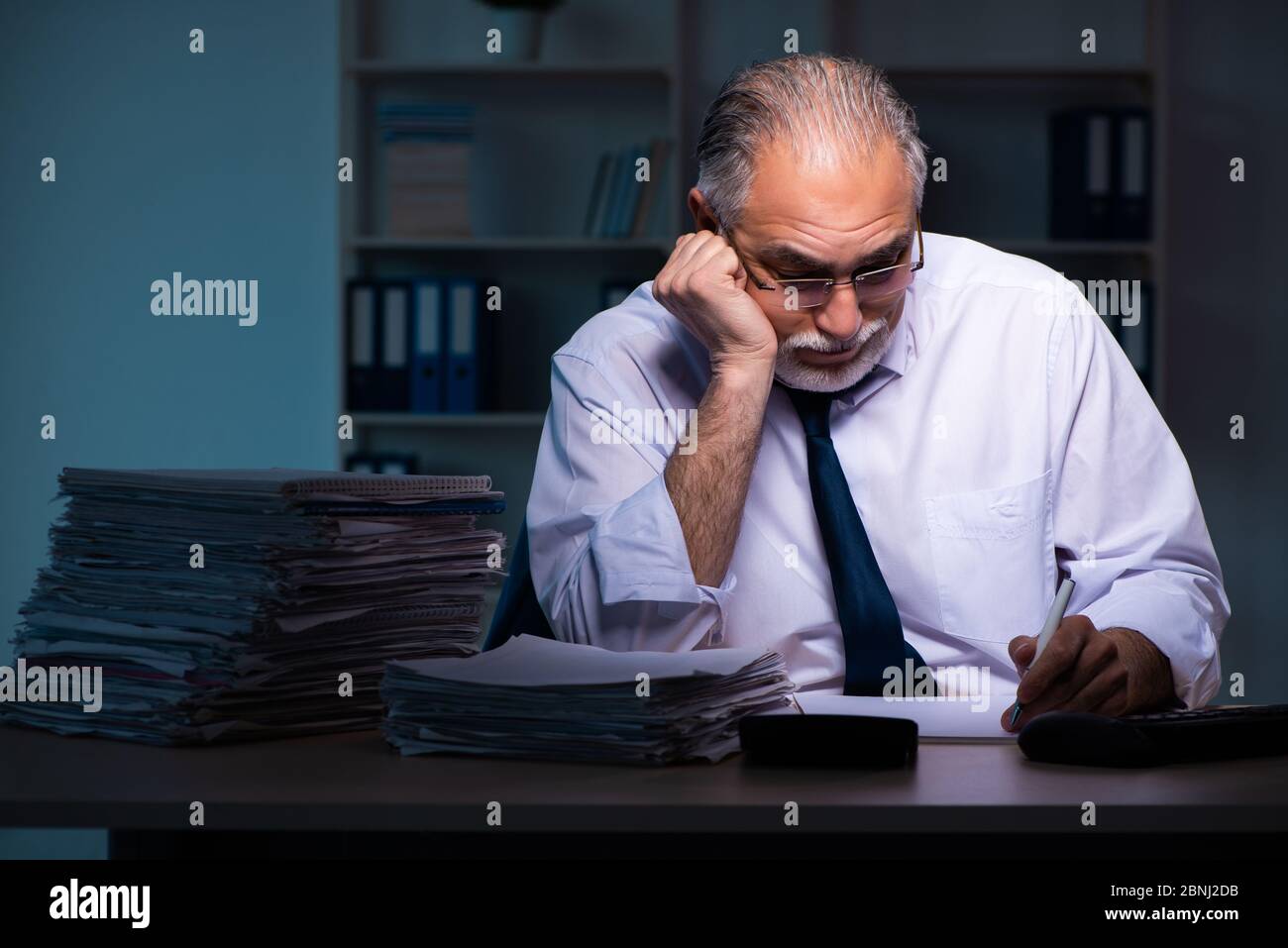 Old employee working late in the office Stock Photo - Alamy