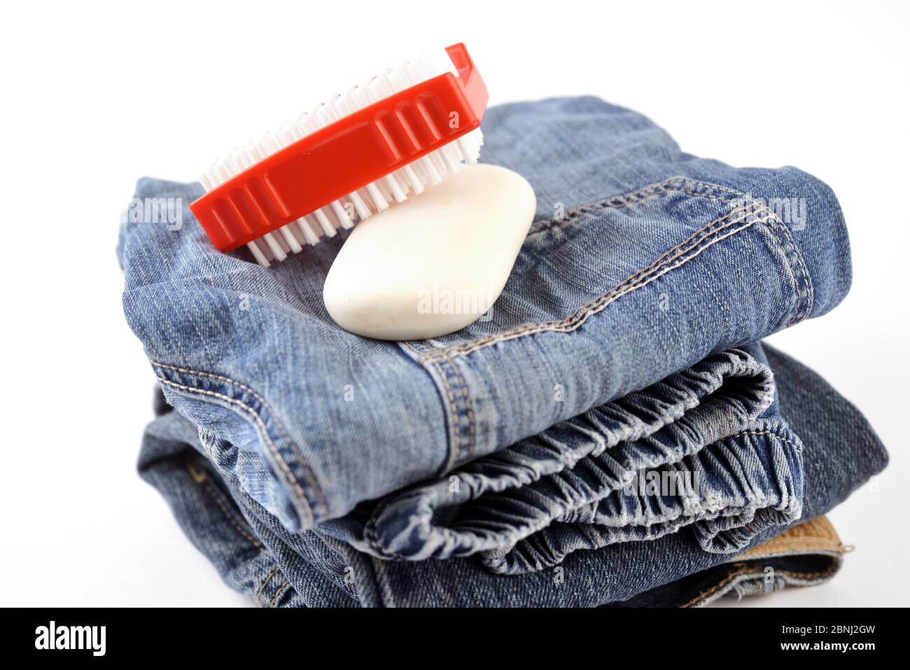 Jeans trousers with red brush and soap ready for cleaning Stock Photo ...