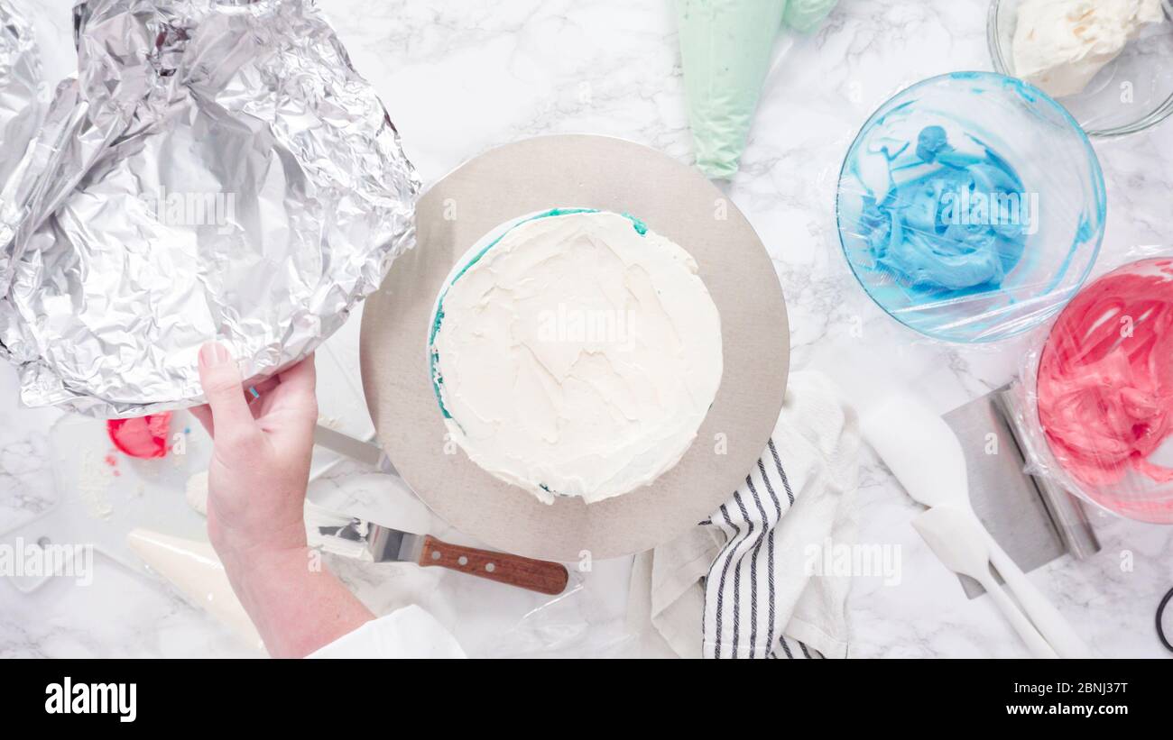 Stacking cake layers to create the round three-layer vanilla cake Stock ...