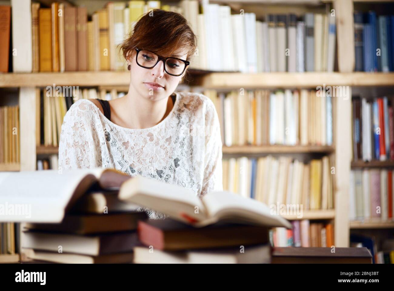 Beautiful woman reading many books hi-res stock photography and images ...