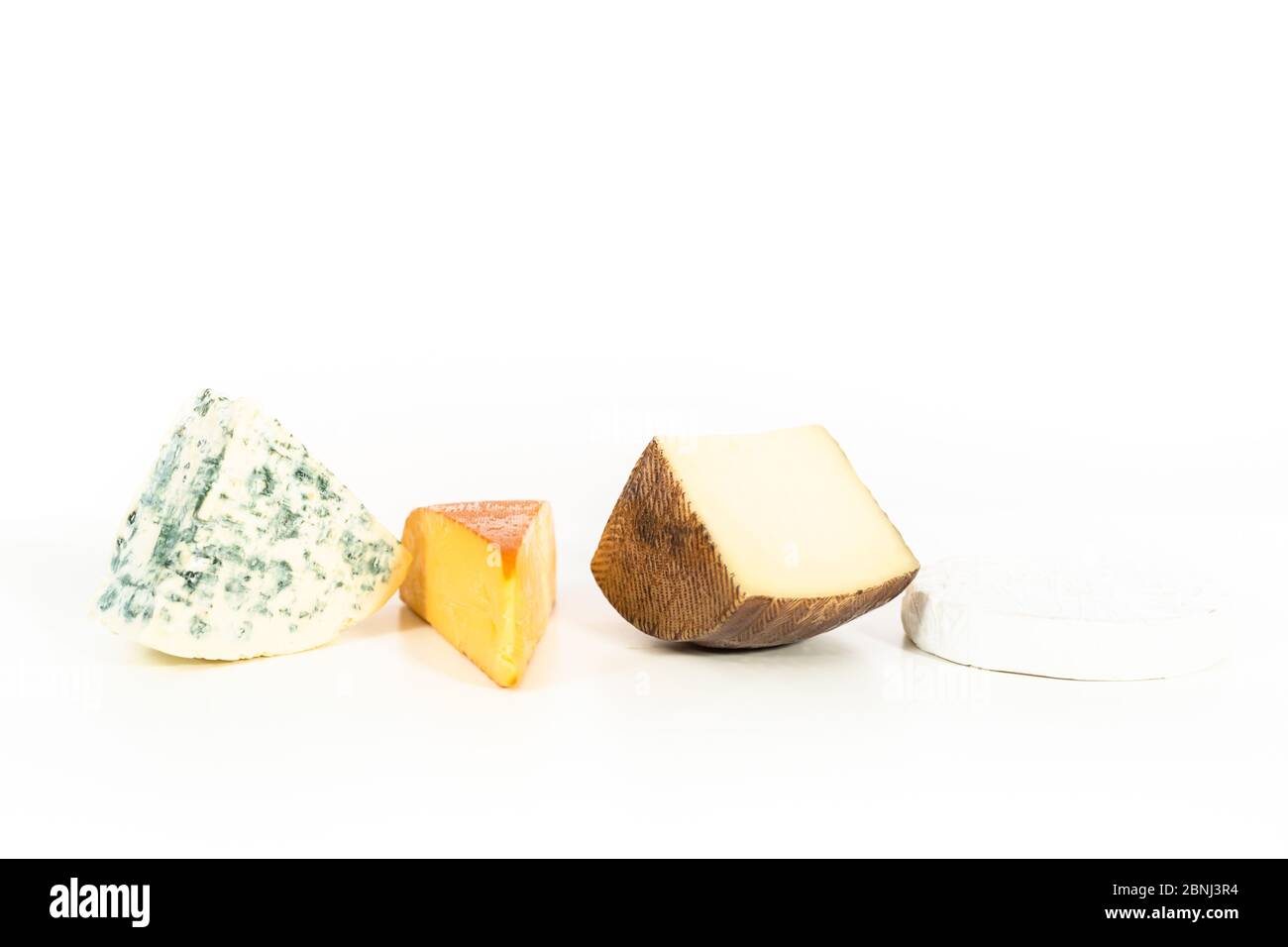 Variety of large wedges gourmet cheese on a white background Stock ...