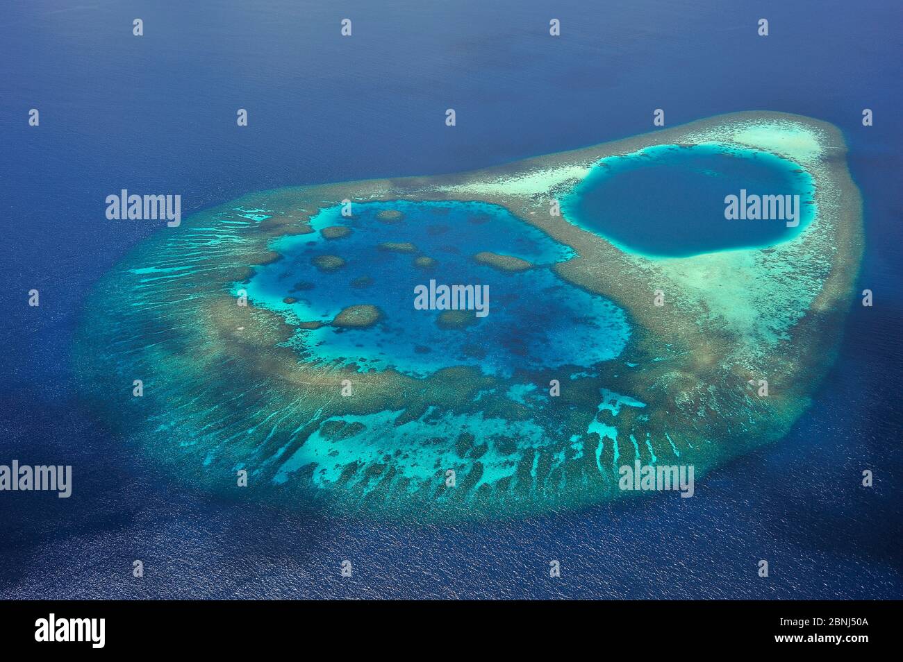 Aerial view of the coral reef which builds a lagoon in the atoll ...