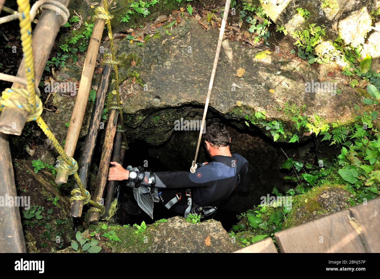 A diver prepares to go down with a pulley to a 20metre deep cenote ...