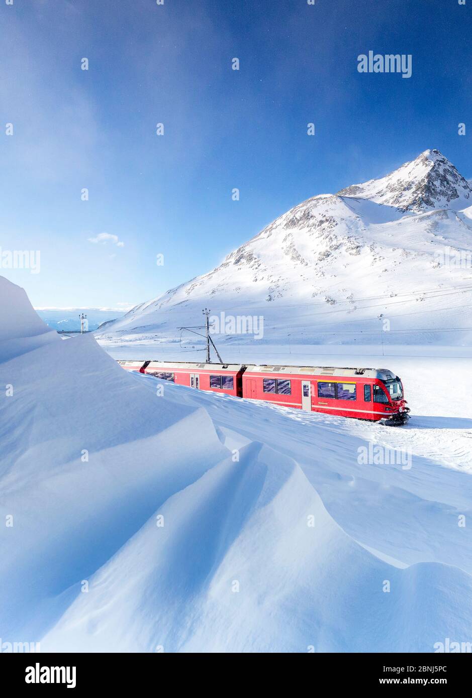 Bernina Express transit along Lago Bianco during winter blizzard ...
