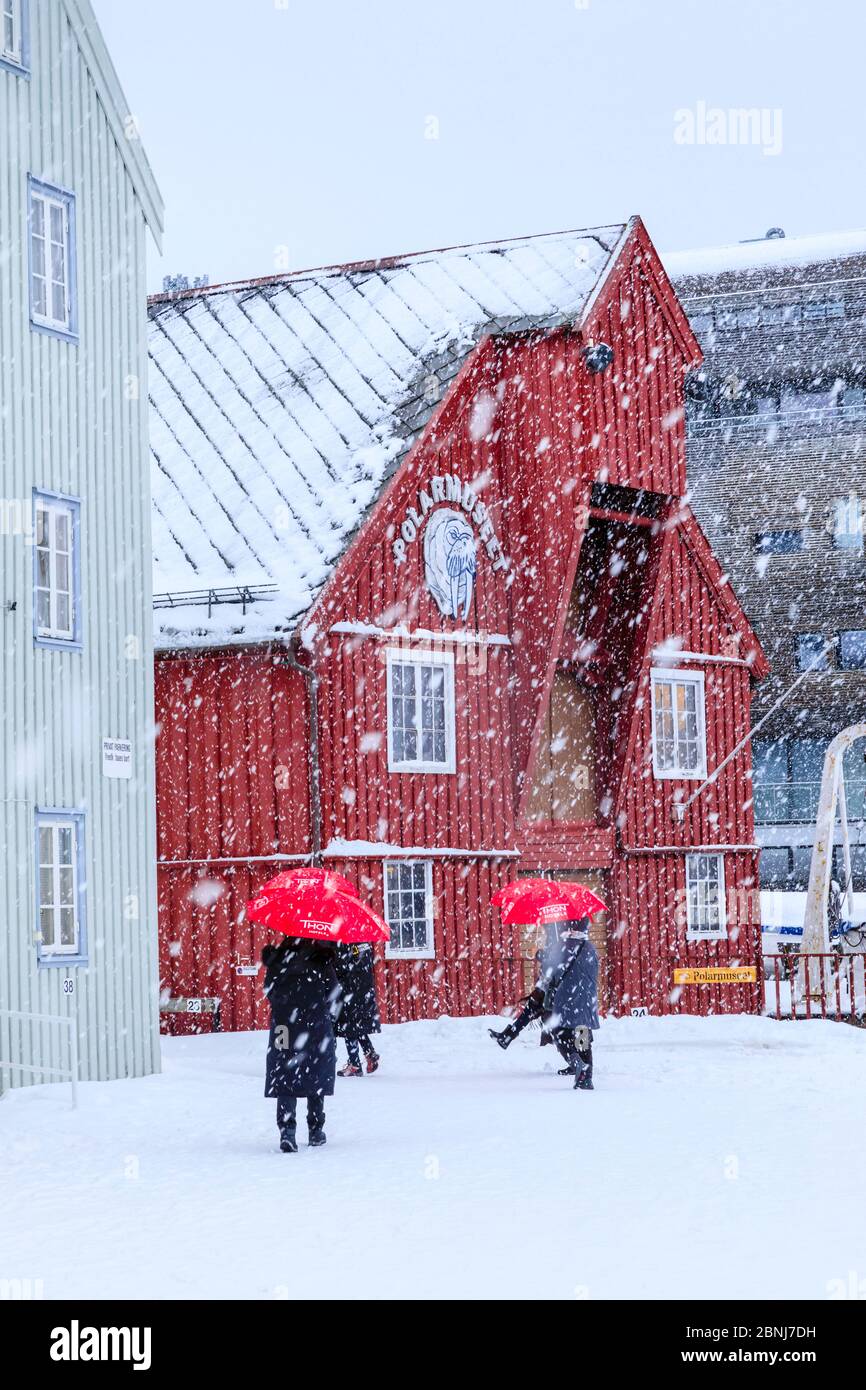 Tourists, colourful historic wooden buildings, heavy snow in winter ...