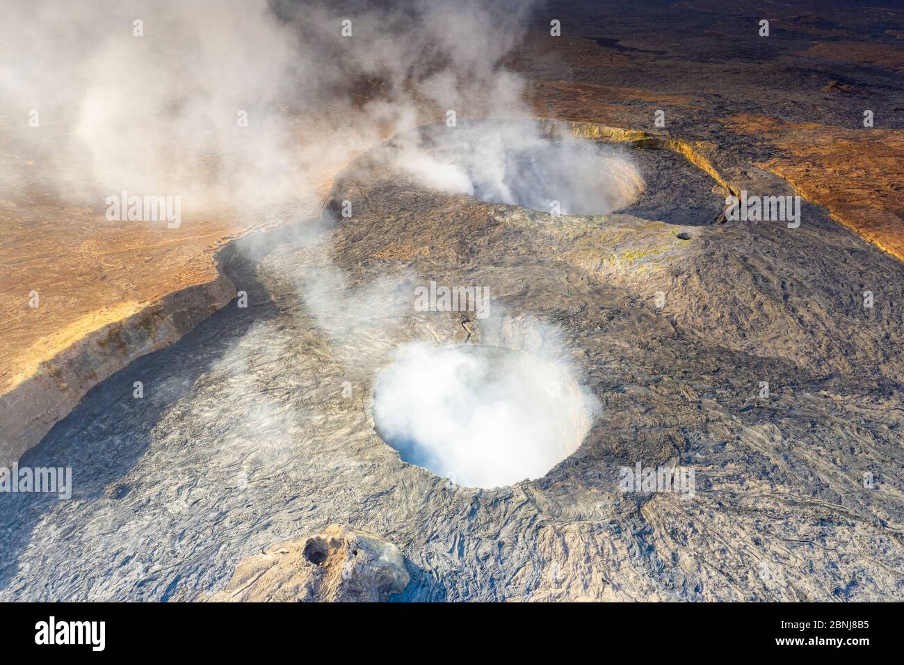 Smoke over the two craters of Erta Ale volcano summit caldera, Danakil ...