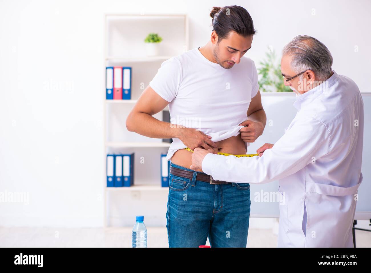 The doctor dietician giving advices to fat overweight patient Stock ...