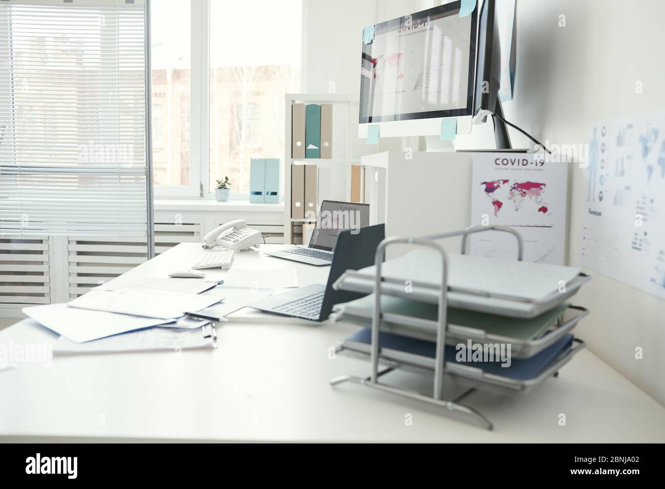 Image of workplace with computer monitor on it and documents at the ...