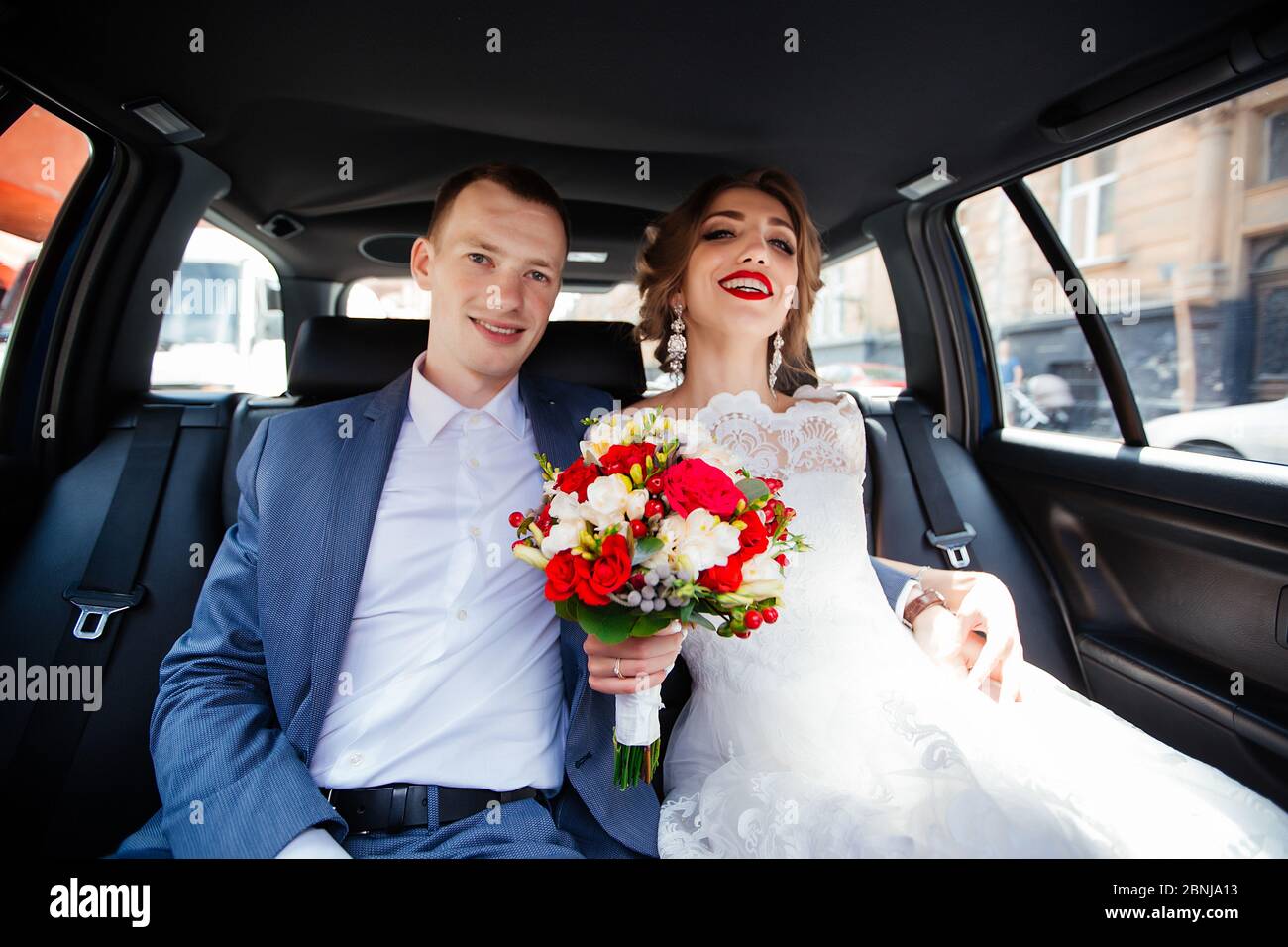 brides in a car driving through the city Stock Photo - Alamy