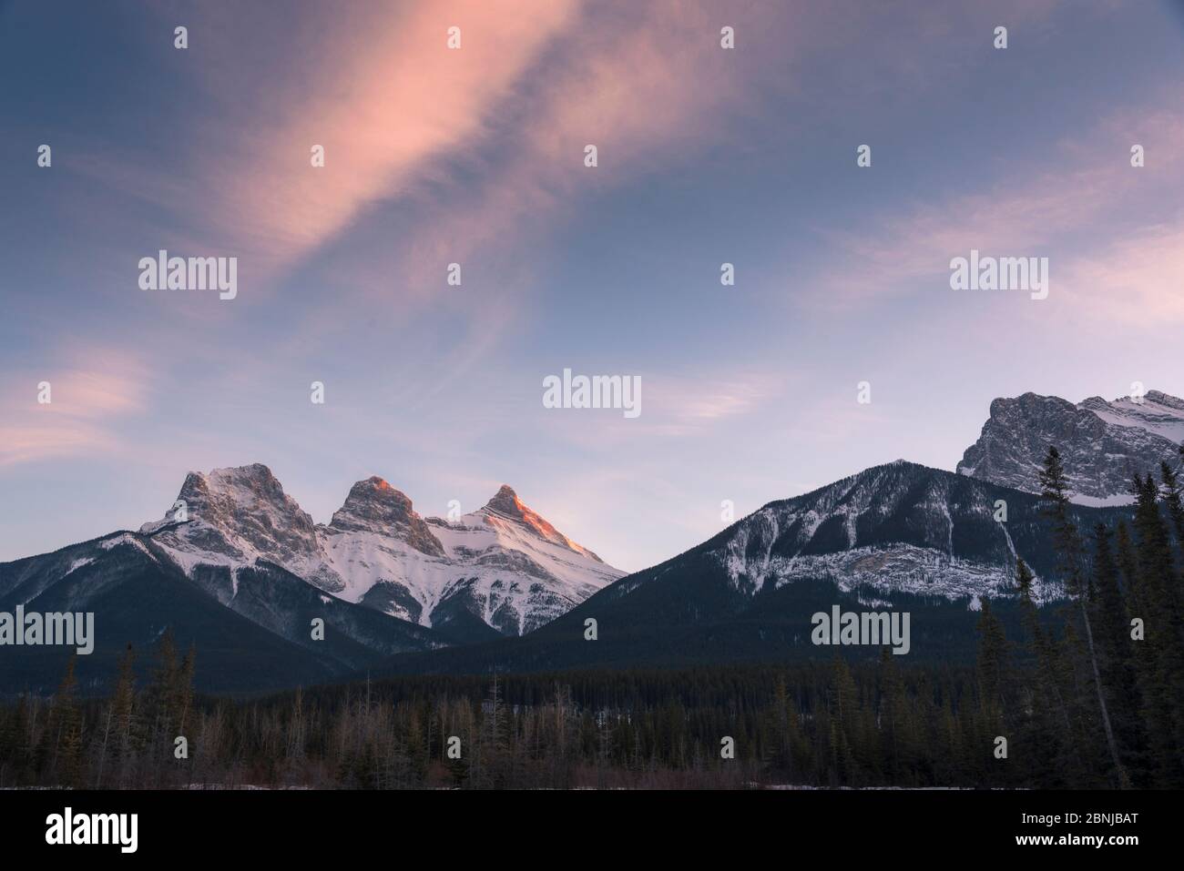 Evening light on the peaks of Three Sisters near Banff National Park, Canmore, Alberta, Canadian ...
