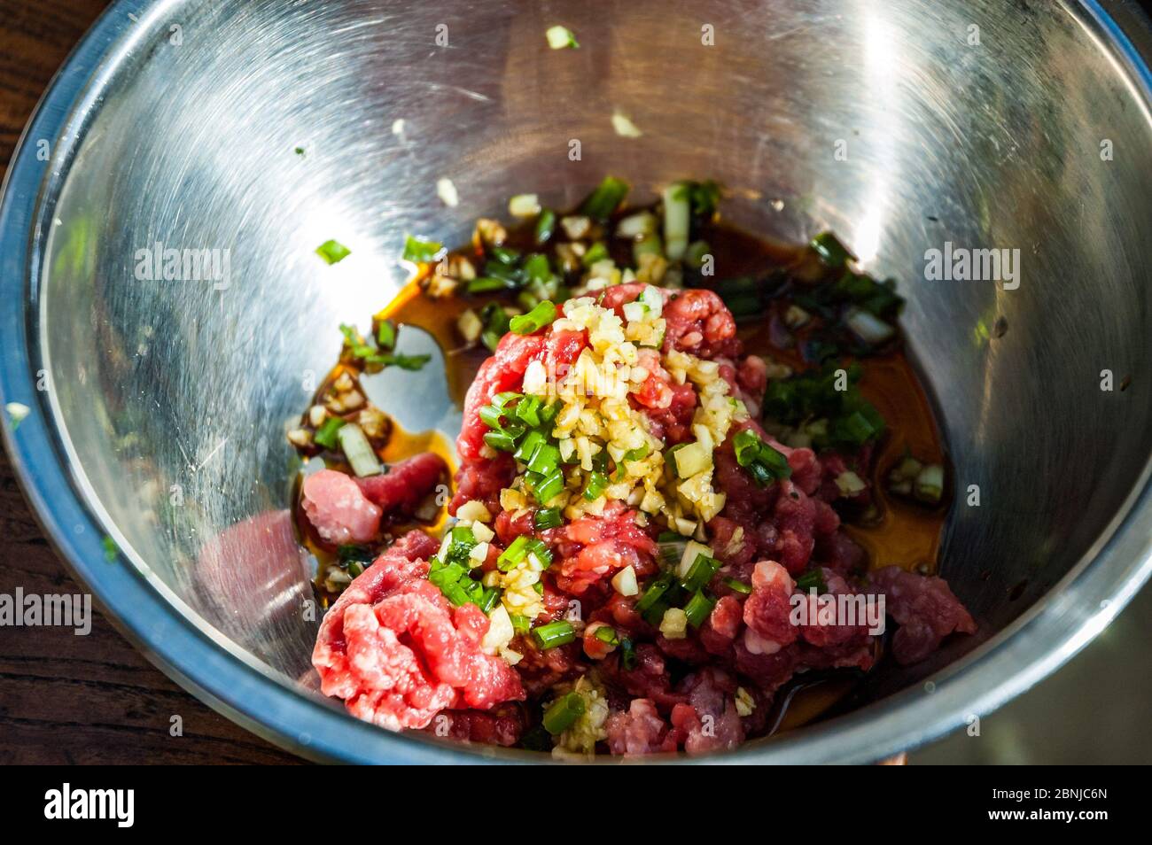 Preparing the meat for the filling of jiaozi dumplings at a Beijing ...
