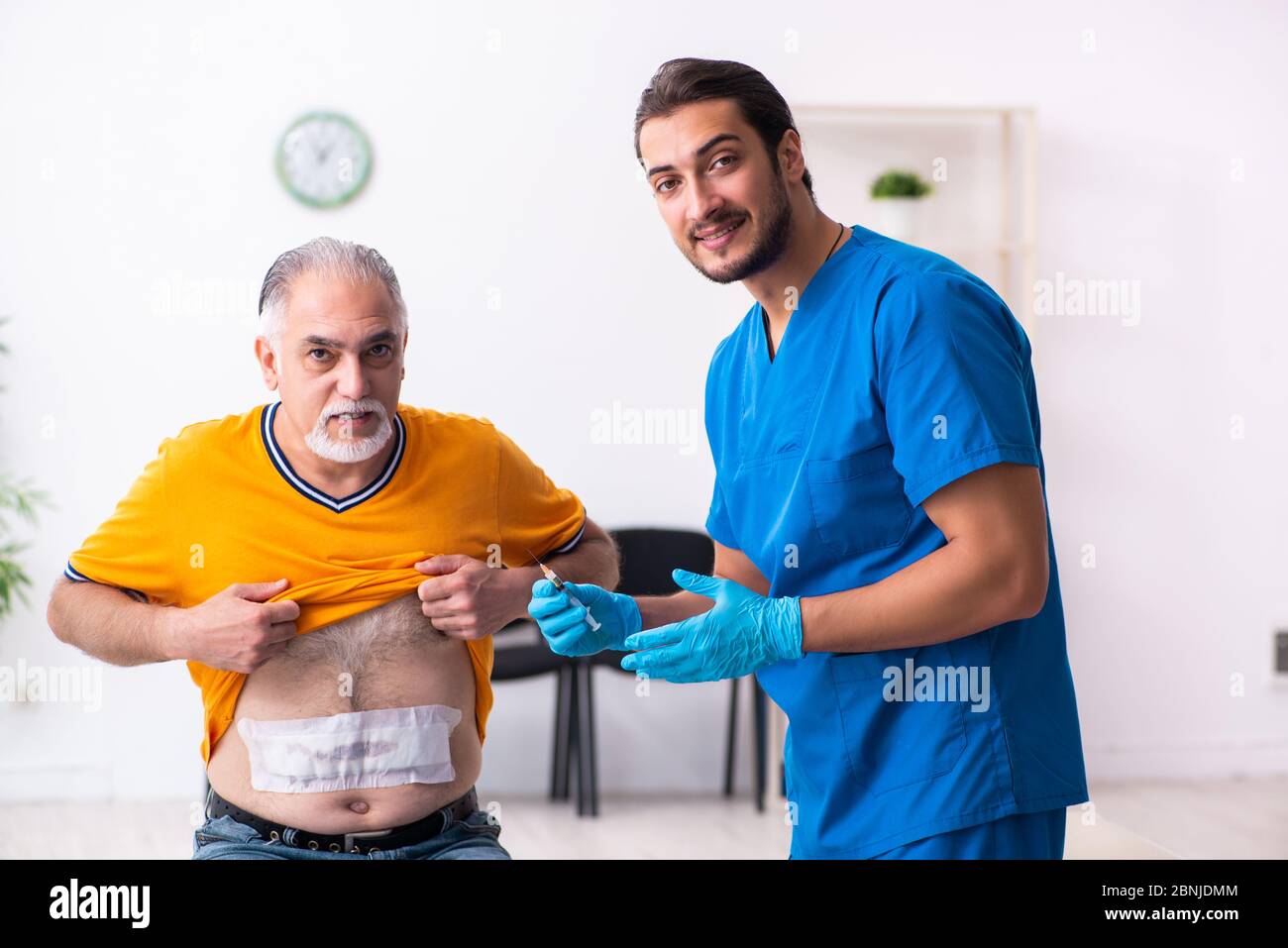 Old man visiting male doctor Stock Photo - Alamy
