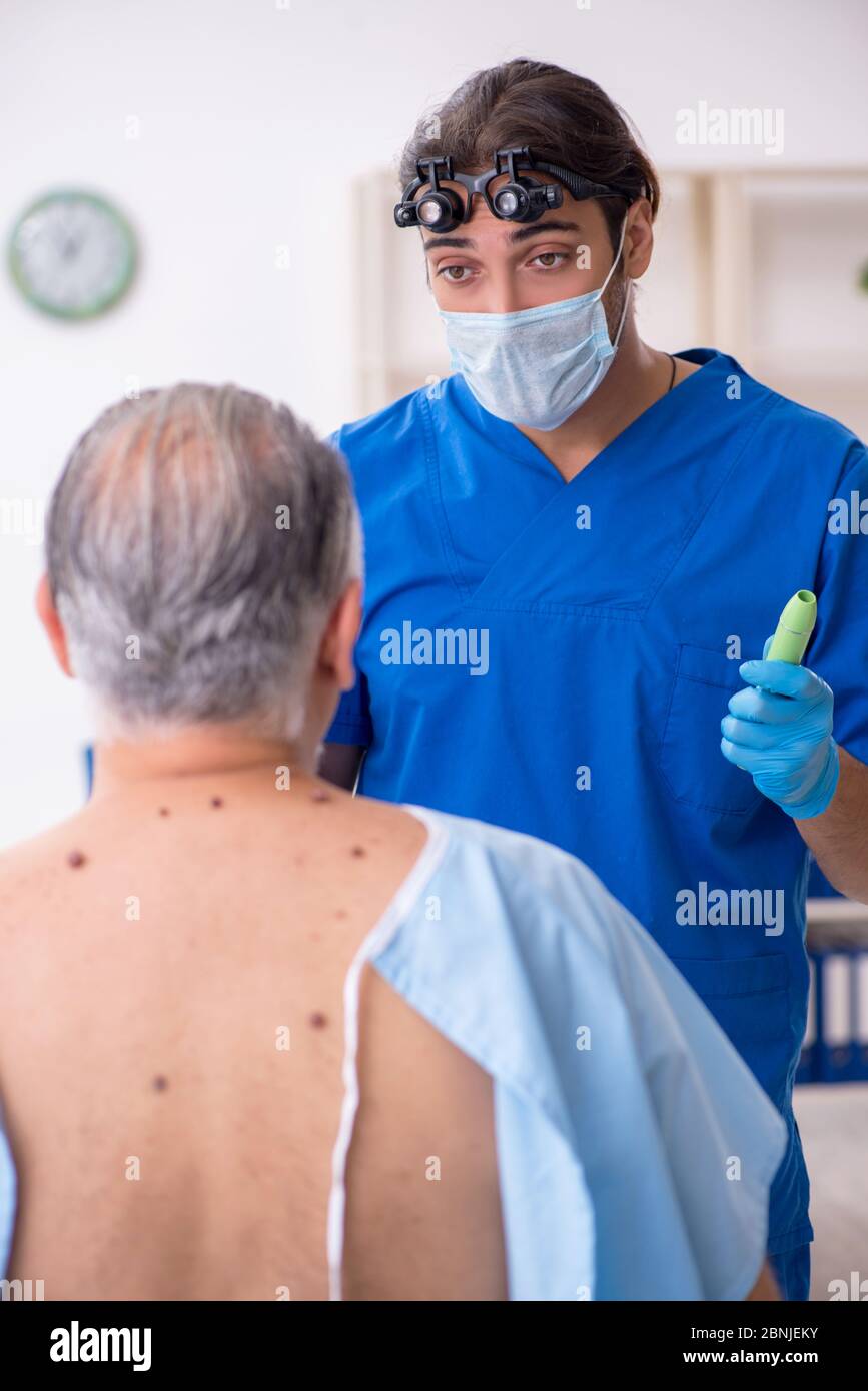 Old man visiting male doctor dermatologist Stock Photo - Alamy