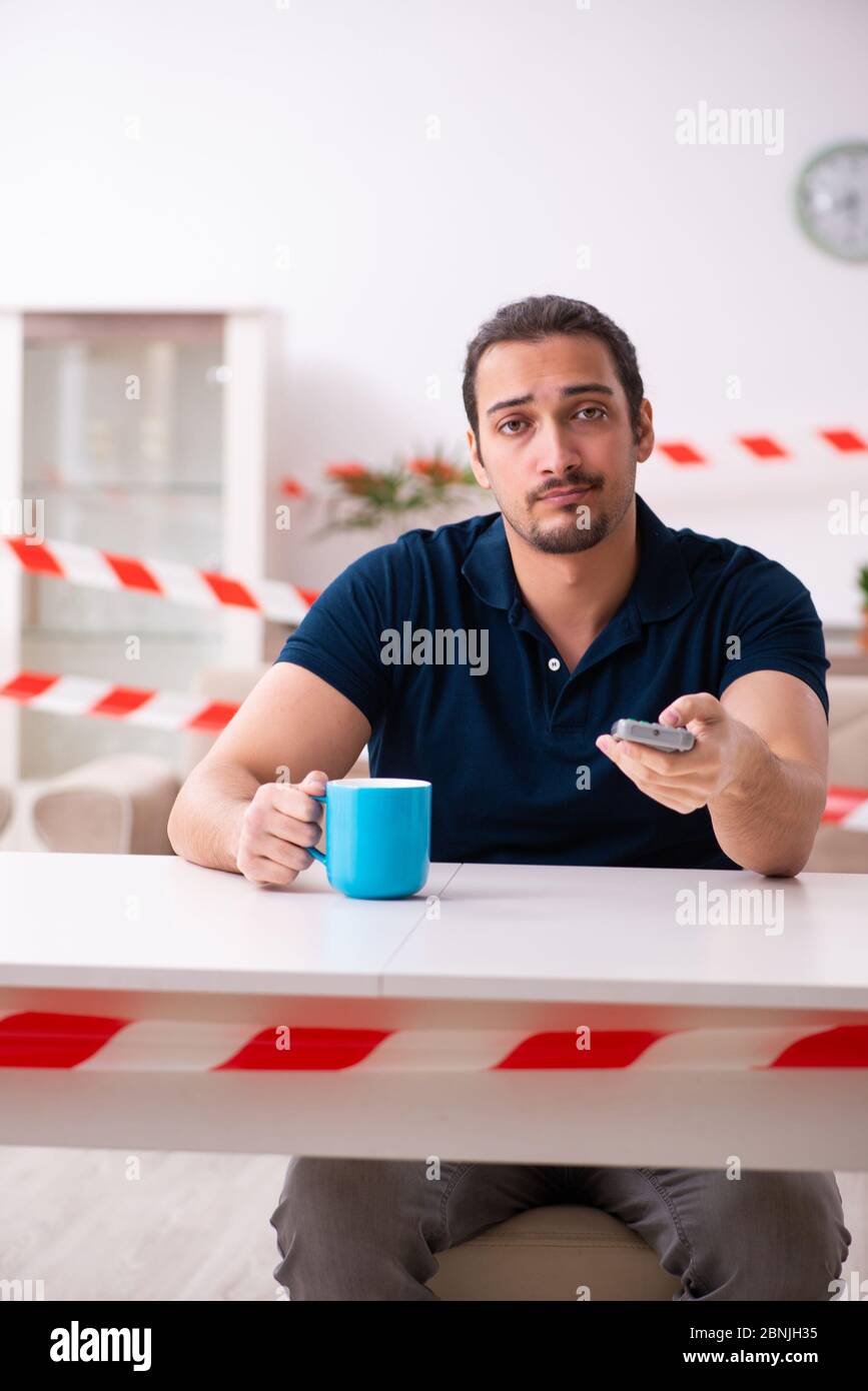 Young man at home in the self-isolation concept Stock Photo - Alamy