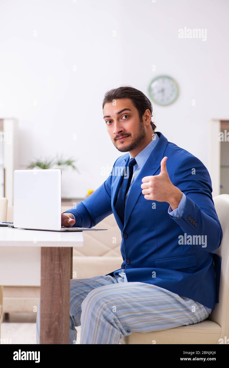 Young employee working from house in self-isolation concept Stock Photo ...