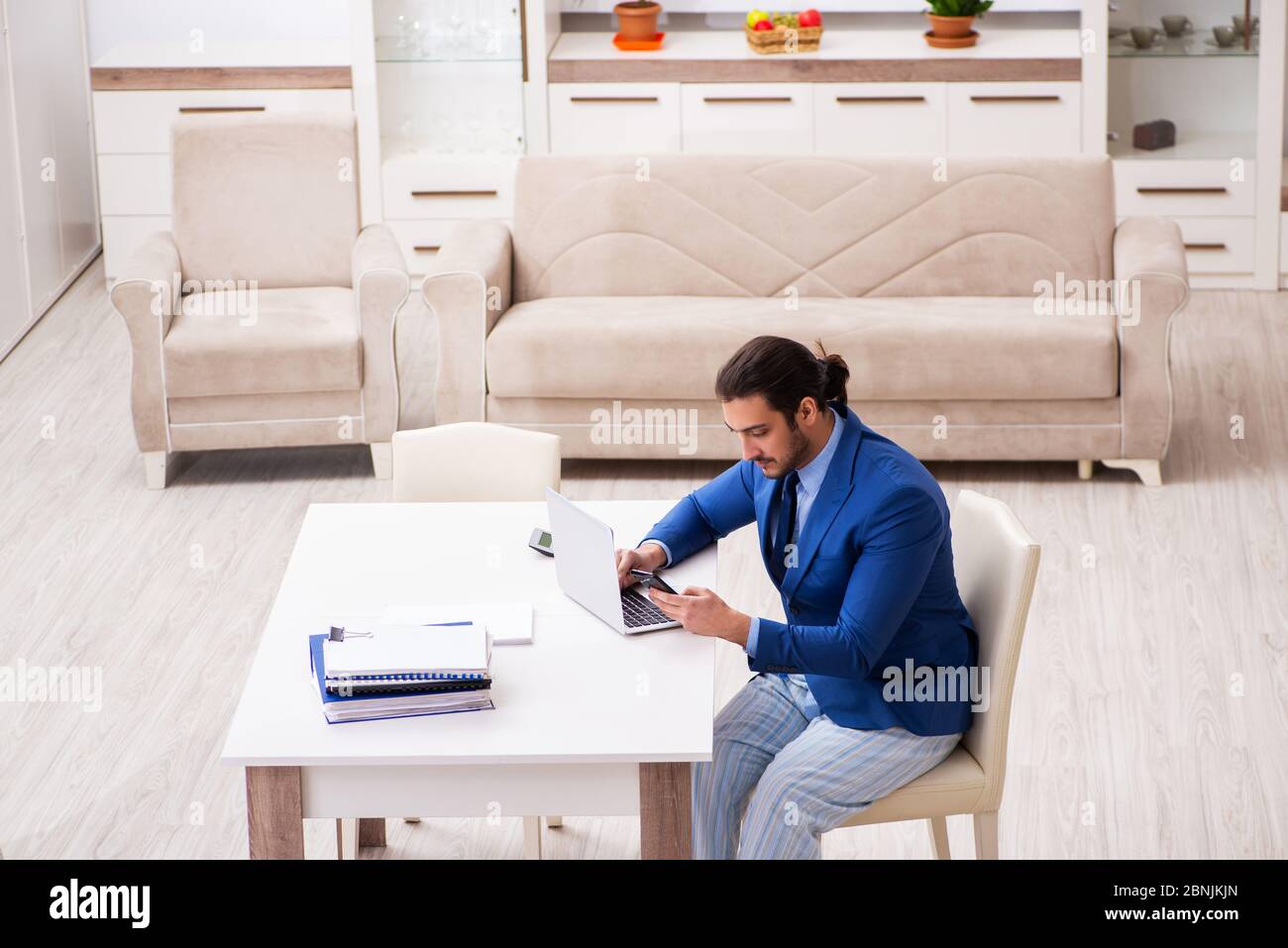 Young employee working from house in self-isolation concept Stock Photo ...