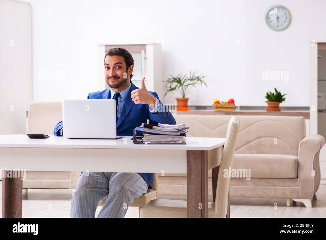 Young employee working from house in self-isolation concept Stock Photo ...