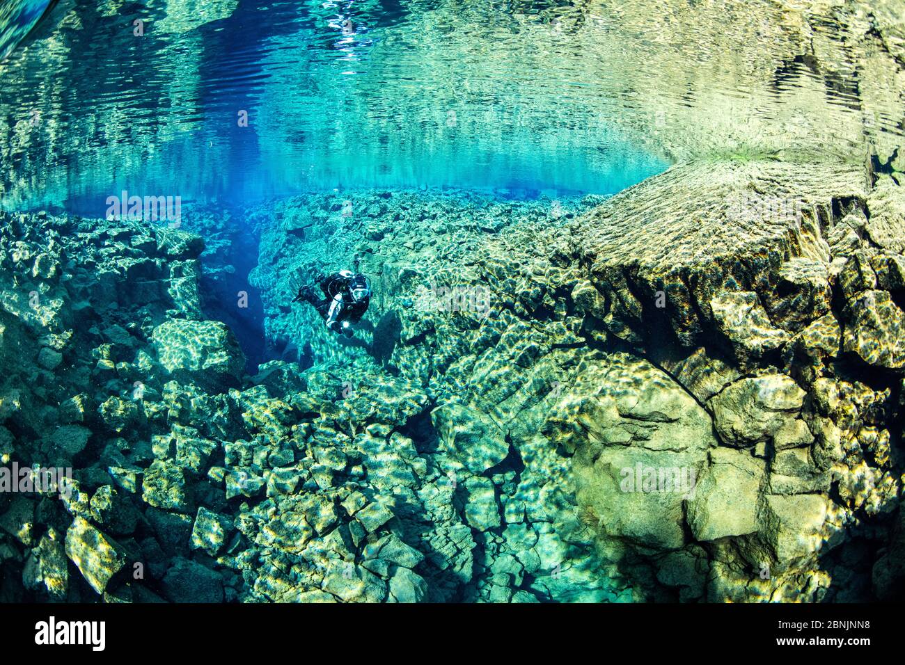 Scuba diver runs through Silfra Hall, a 200 meters up and down swim ...
