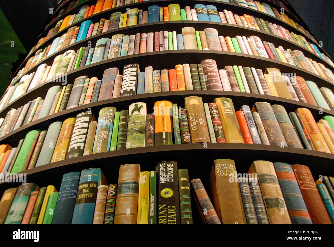 Books in a tower-shaped bookcase Stock Photo - Alamy
