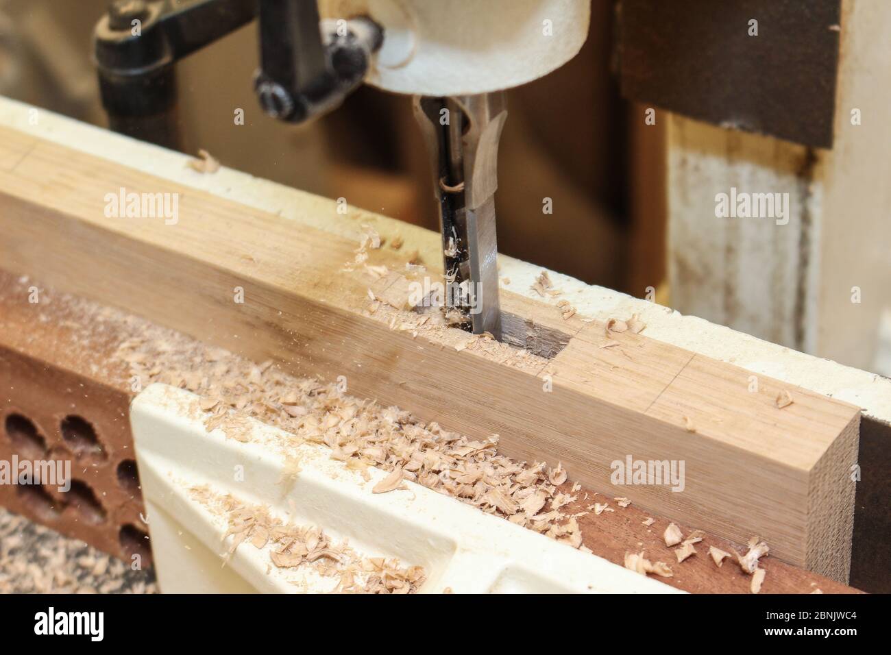 Cutting mortises in oak on a mortising machine, oak mortise Stock Photo ...