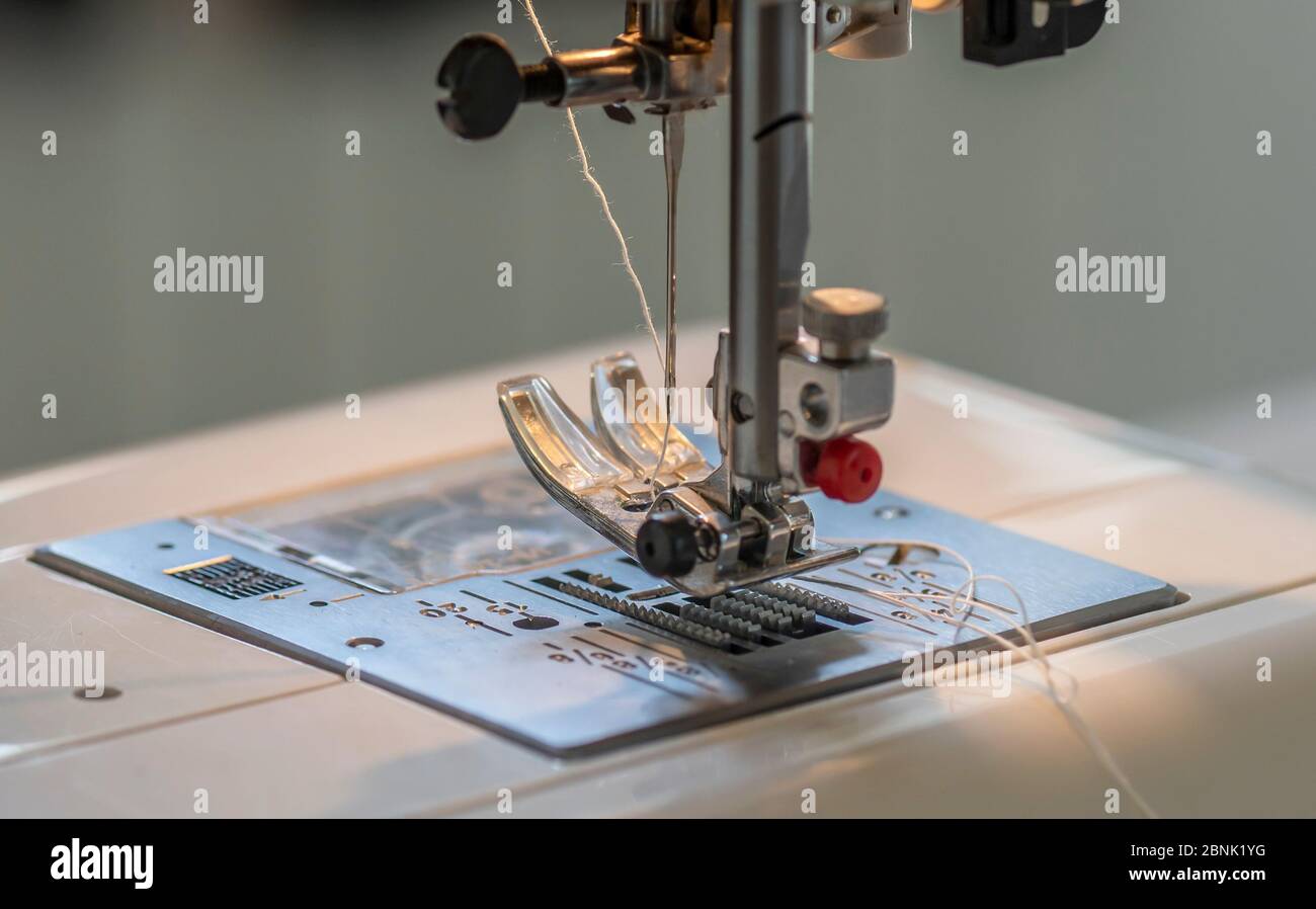 close-up details of a sewing machine, a carriage and a sewing needle ...