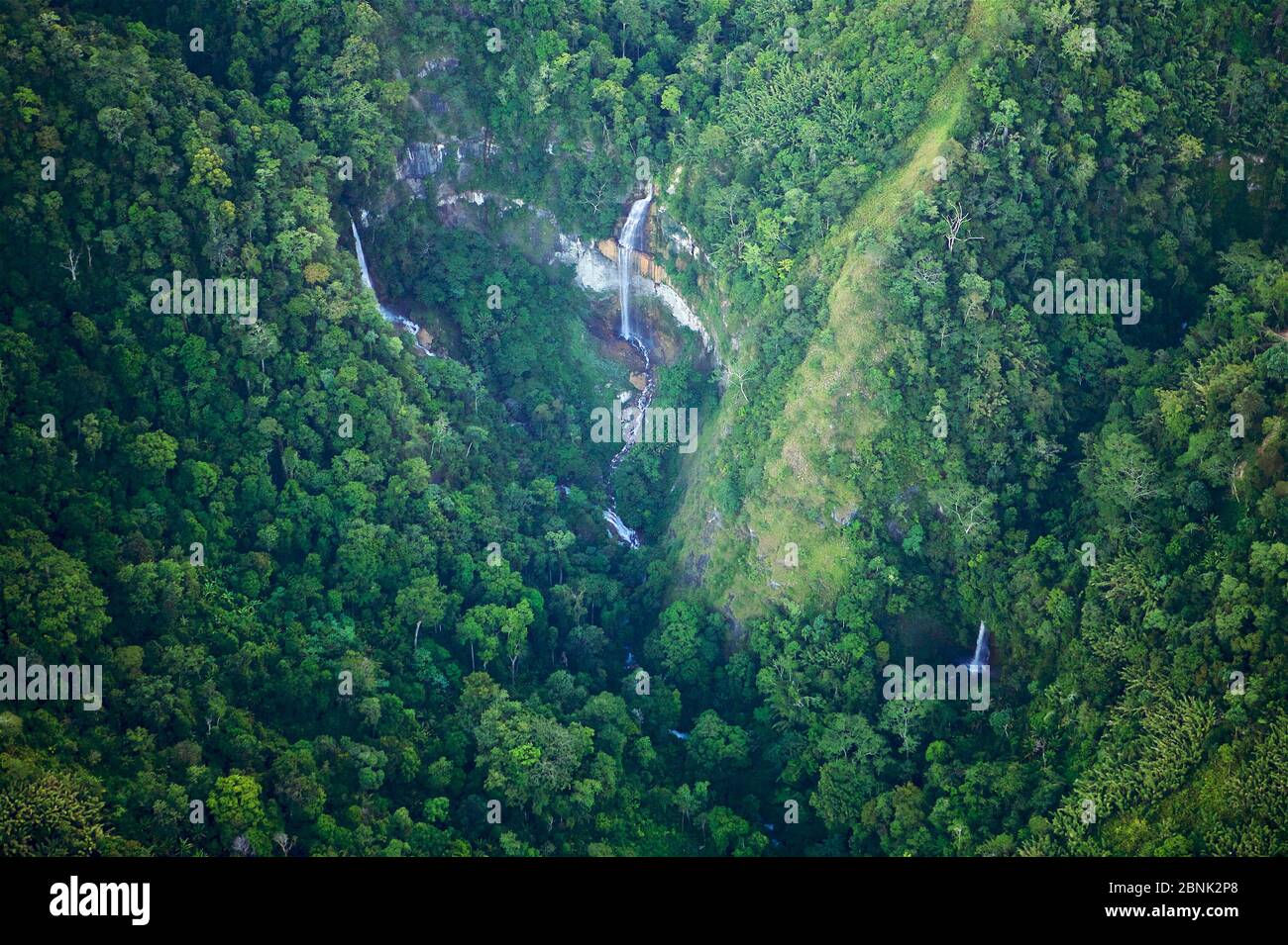 Aerial view of waterfalls in a remote valley of the Huon Peninsula, New ...